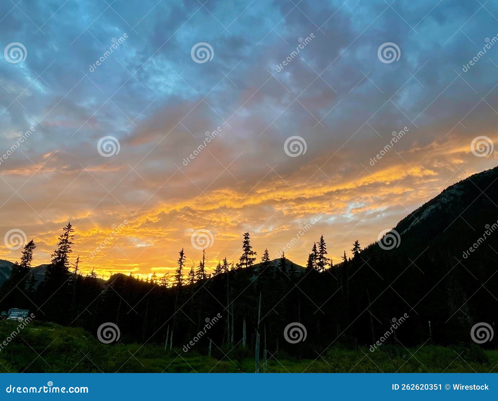 Scenic Low Angle Shot of a Mountain Range on a Grass Field during ...
