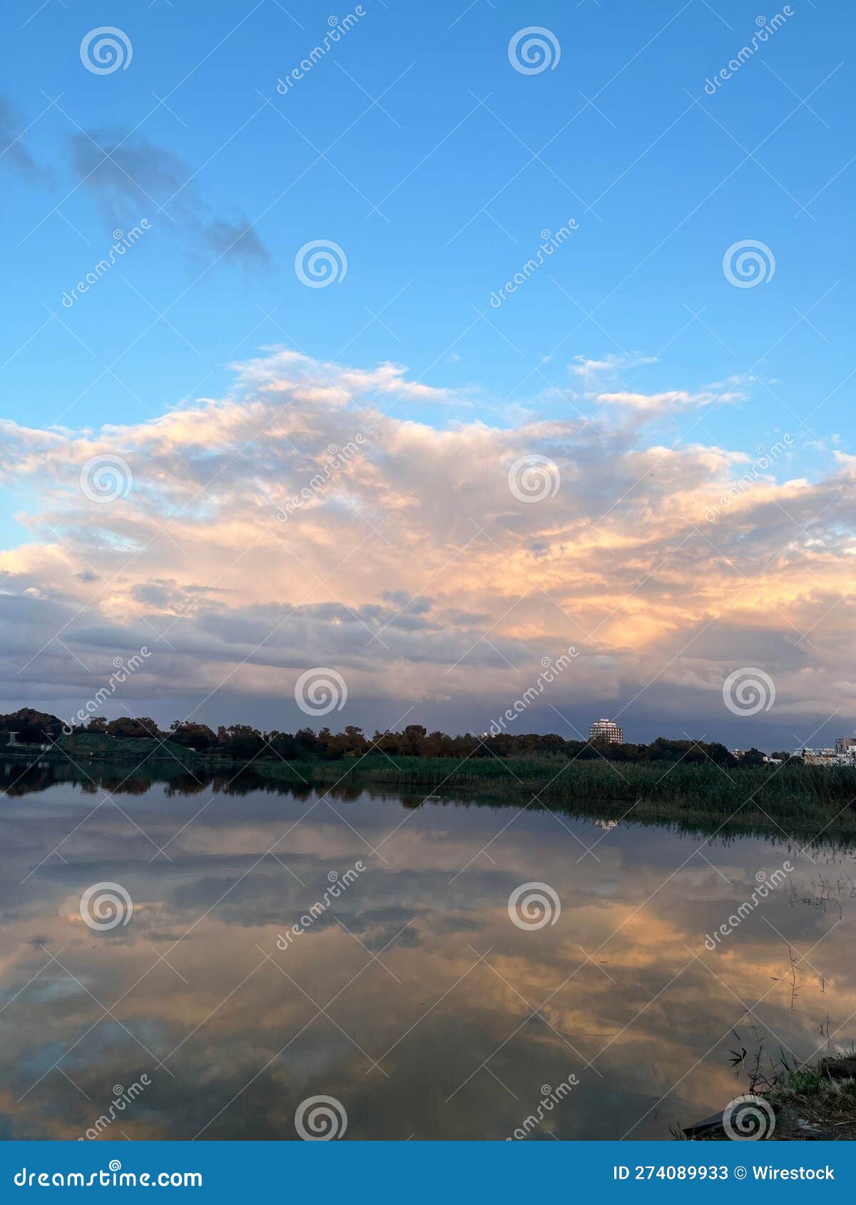 A Scenic Scene with a River in the Foreground and Large Clouds in the ...