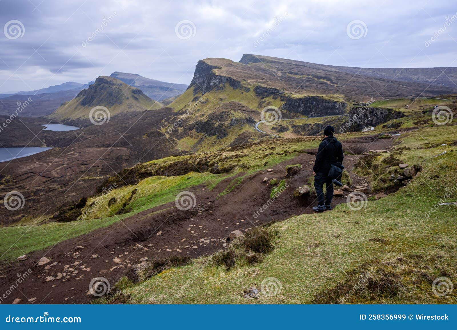 Scenic Shot of a Man Standing in the Quiraing Rock Formations on the ... Scenic Shot of a Man Standing in the Quiraing Rock Formations on the ...