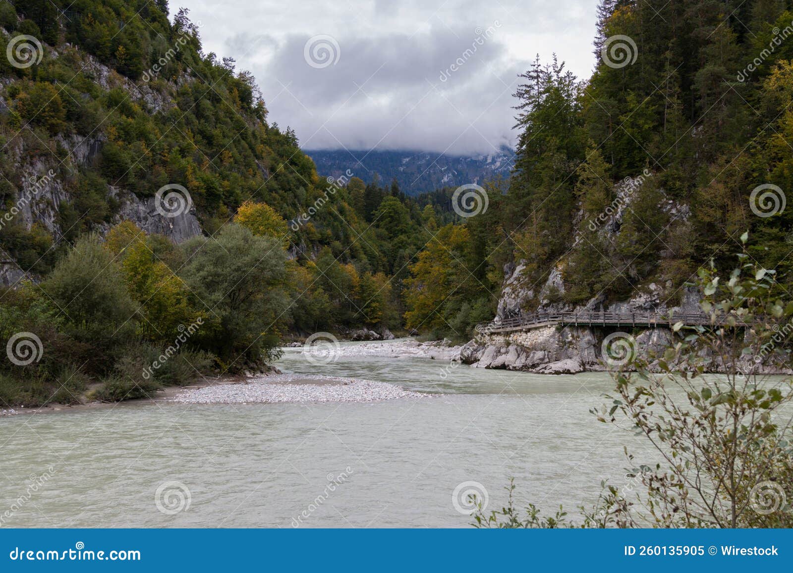 Scenic Shot of a River Flowing between High Mountains and Trees with a ...