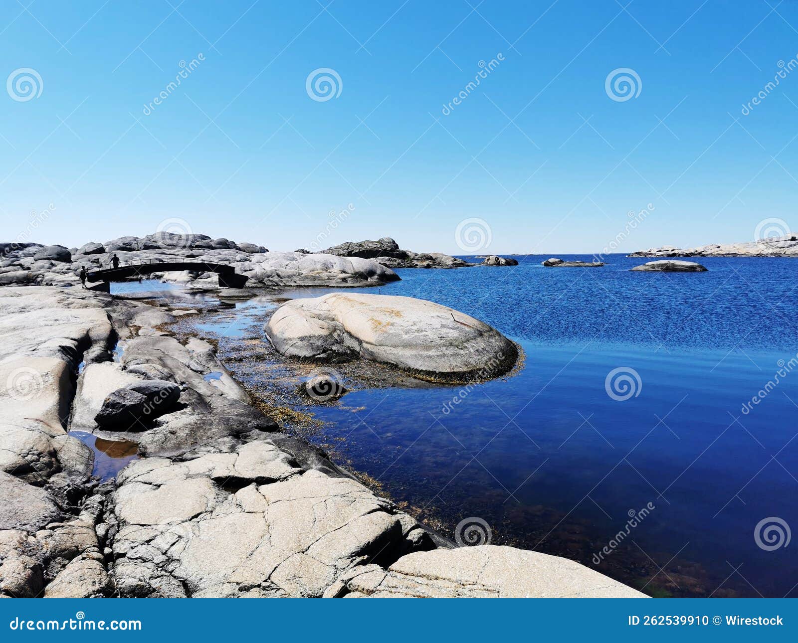 Scenic Shot of a Sea Surrounded by Stone Mountains in Verdens Ende ... Scenic Shot of a Sea Surrounded by Stone Mountains in Verdens Ende ...