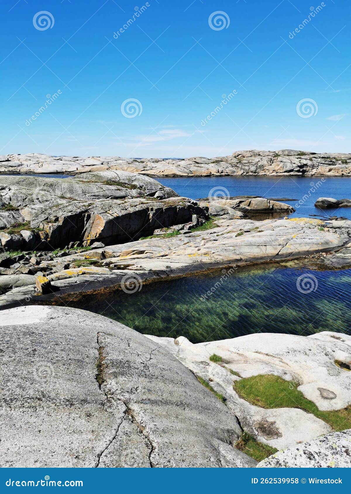 Scenic Shot of a Sea Surrounded by Stone Mountains in Verdens Ende ... Scenic Shot of a Sea Surrounded by Stone Mountains in Verdens Ende ...
