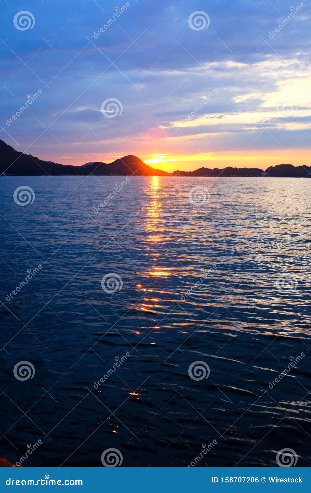 Scenic Shot of the Sunset Reflected in the Ocean Under the Beautiful ...
