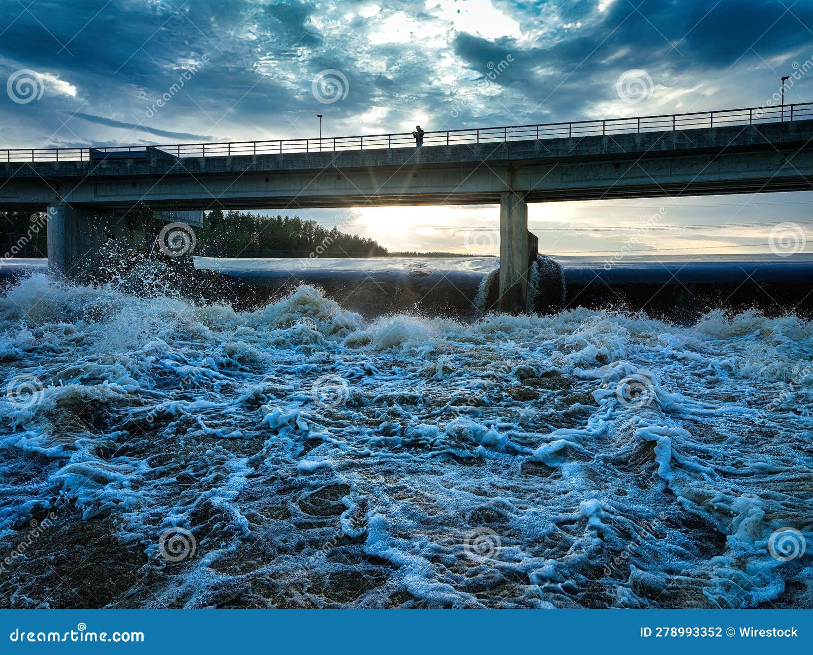 Scenic View of a Bridge Spanning a River with Rippling Waves Below ...