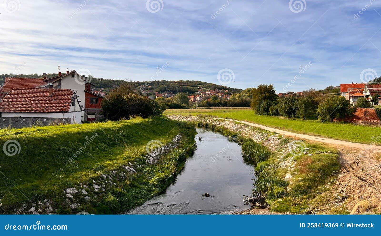 Scenic View of a River Stream Passing through a Village with a ...