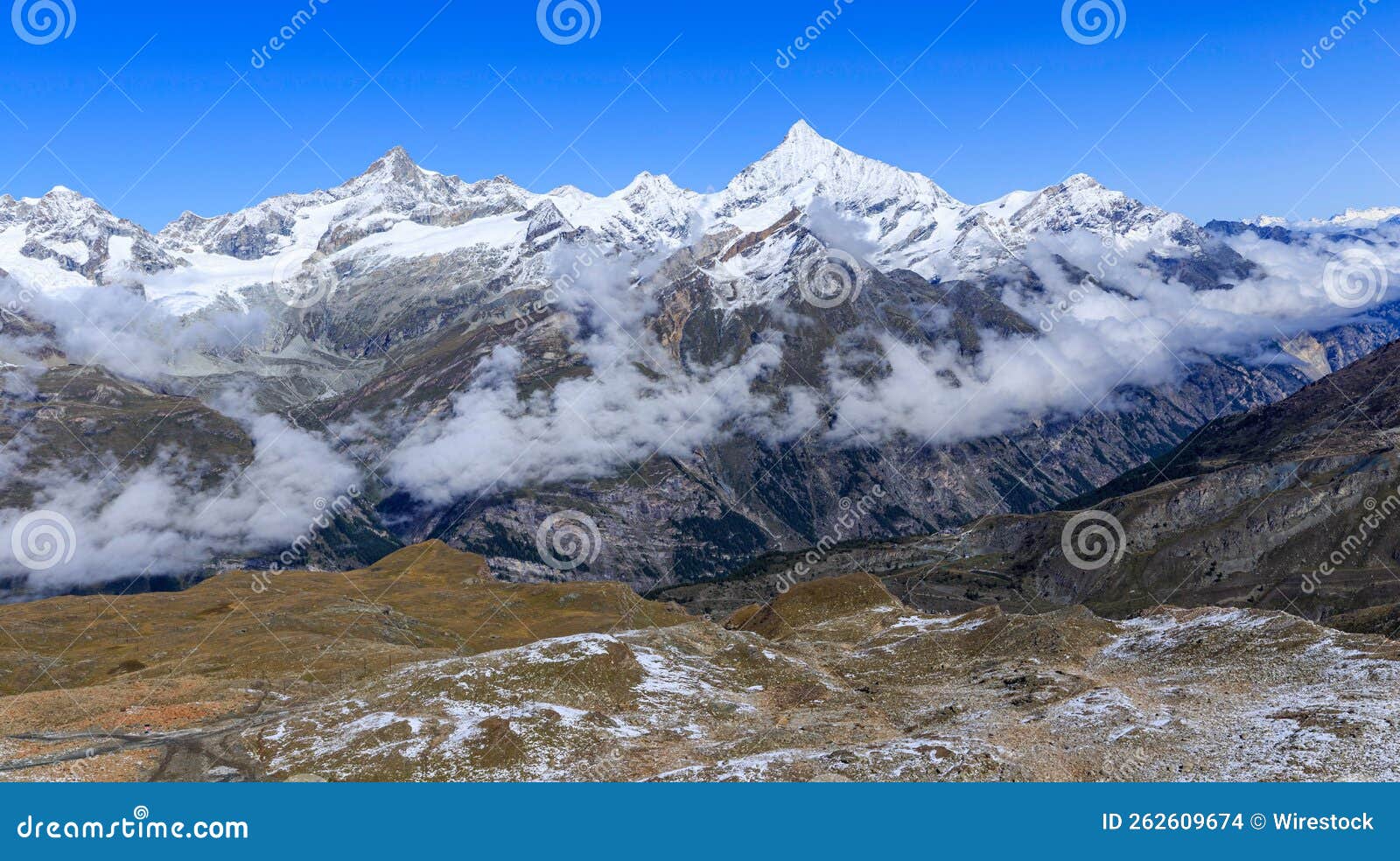 Scenic View of a Slope of a Mountain Range with Snowy Peaks on a Cloudy ...