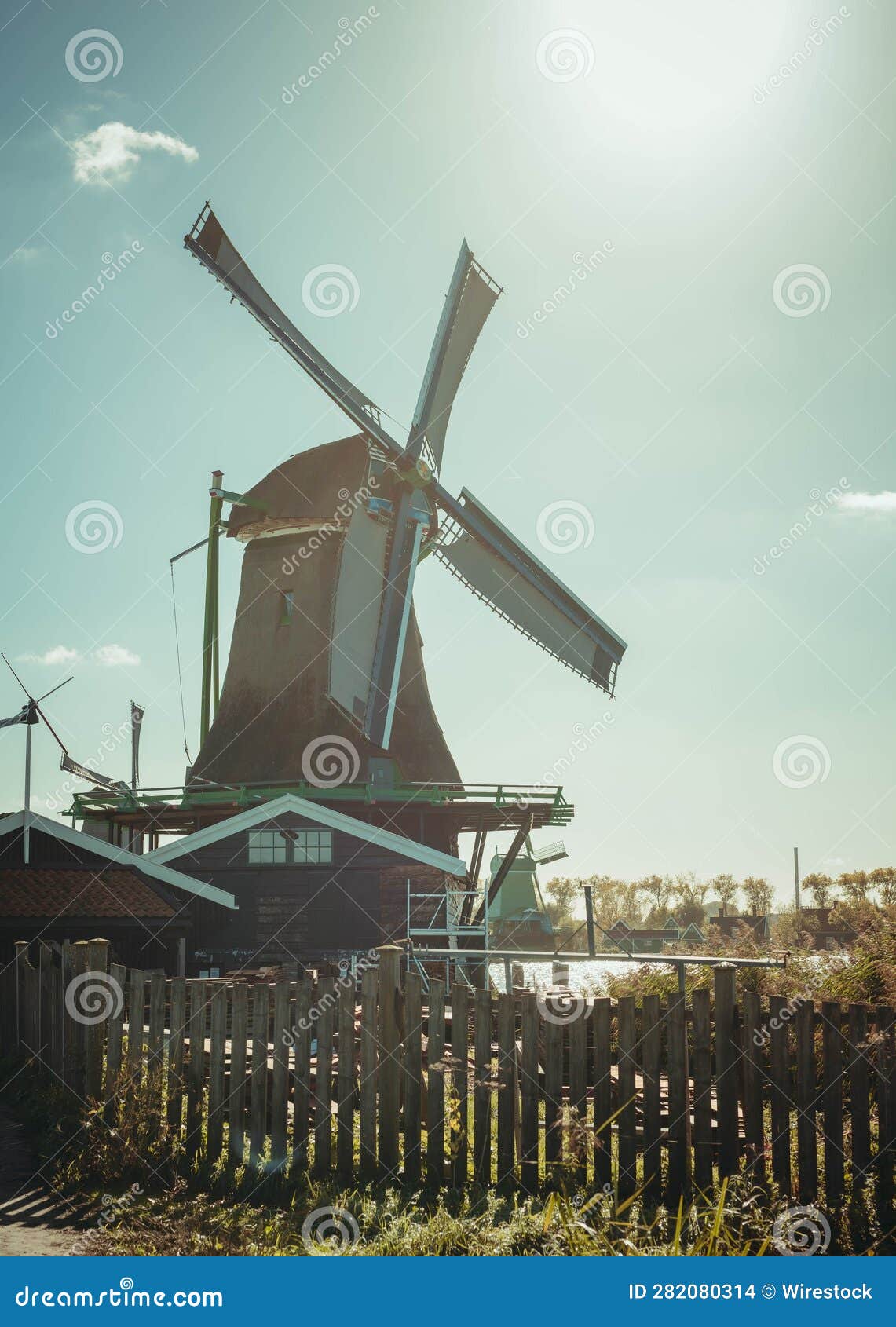 Scenic View of Two Windmills Standing in a Small, Sunny, and Rural Area ...