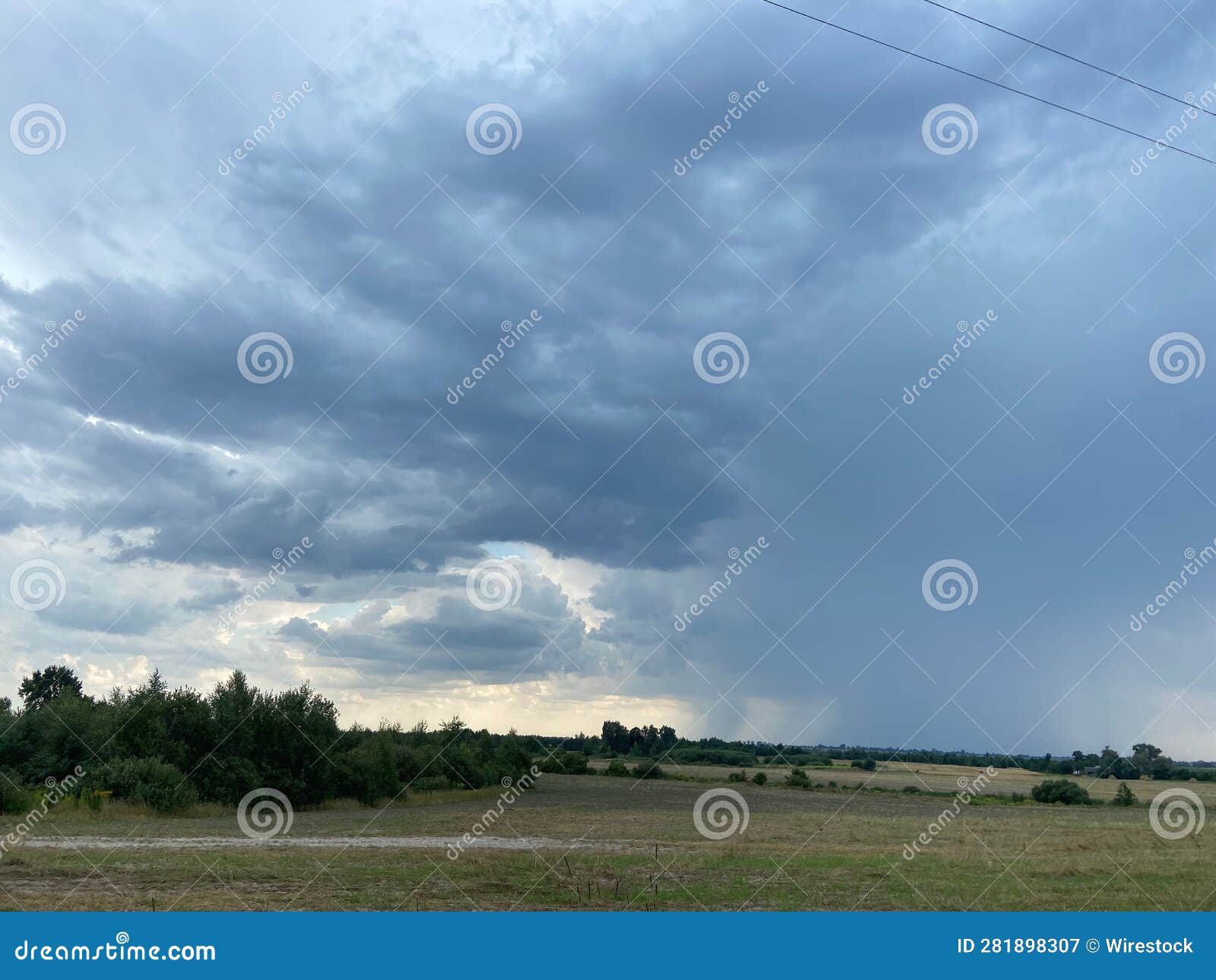 Scenic View of a Vast Open Field with Sparse Trees Under a Cloudy Sky ...