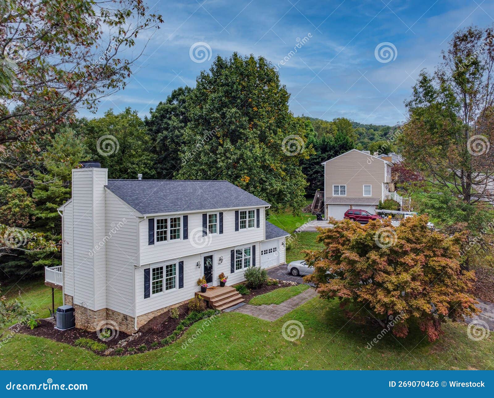 Scenic View of a White Modern House with Its Backyard Full of Greenery ...