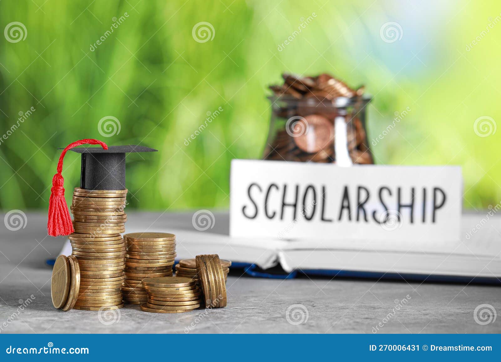 Scholarship Concept. Coins and Graduation Cap on Grey Table, Space for ...