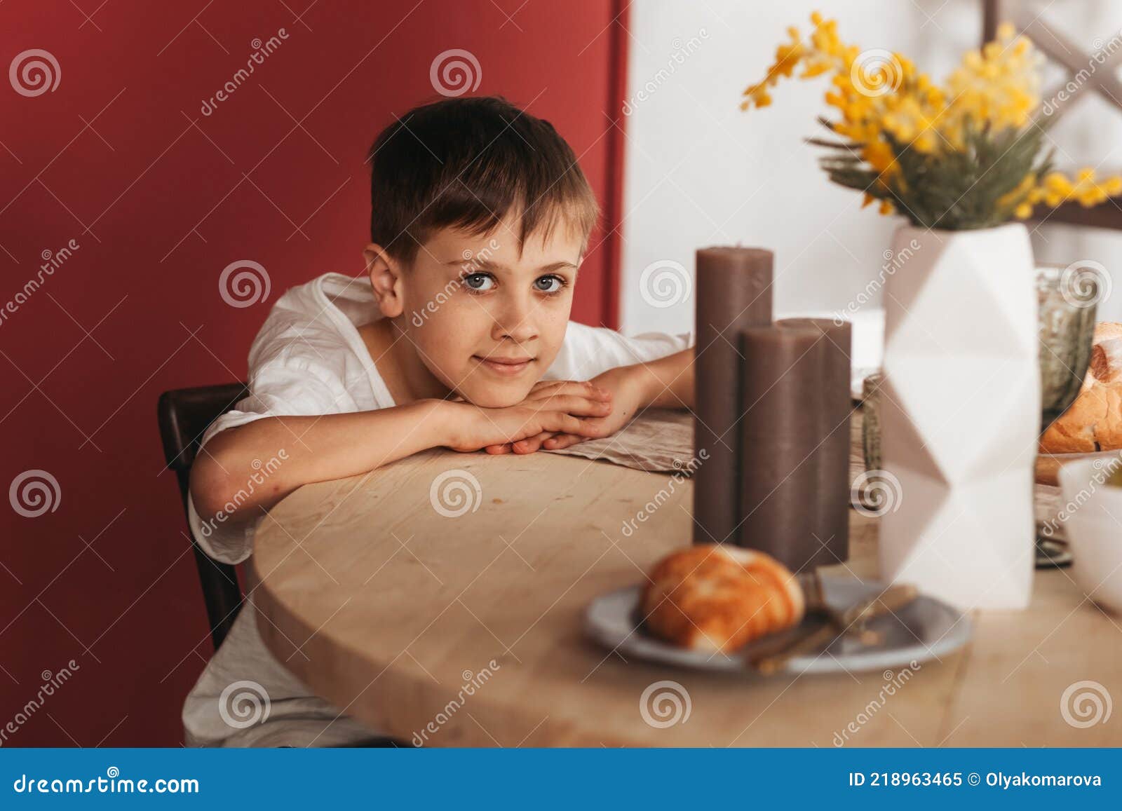 A School-age Boy Sits at the Kitchen Table. Waiting for Lunch Stock ...