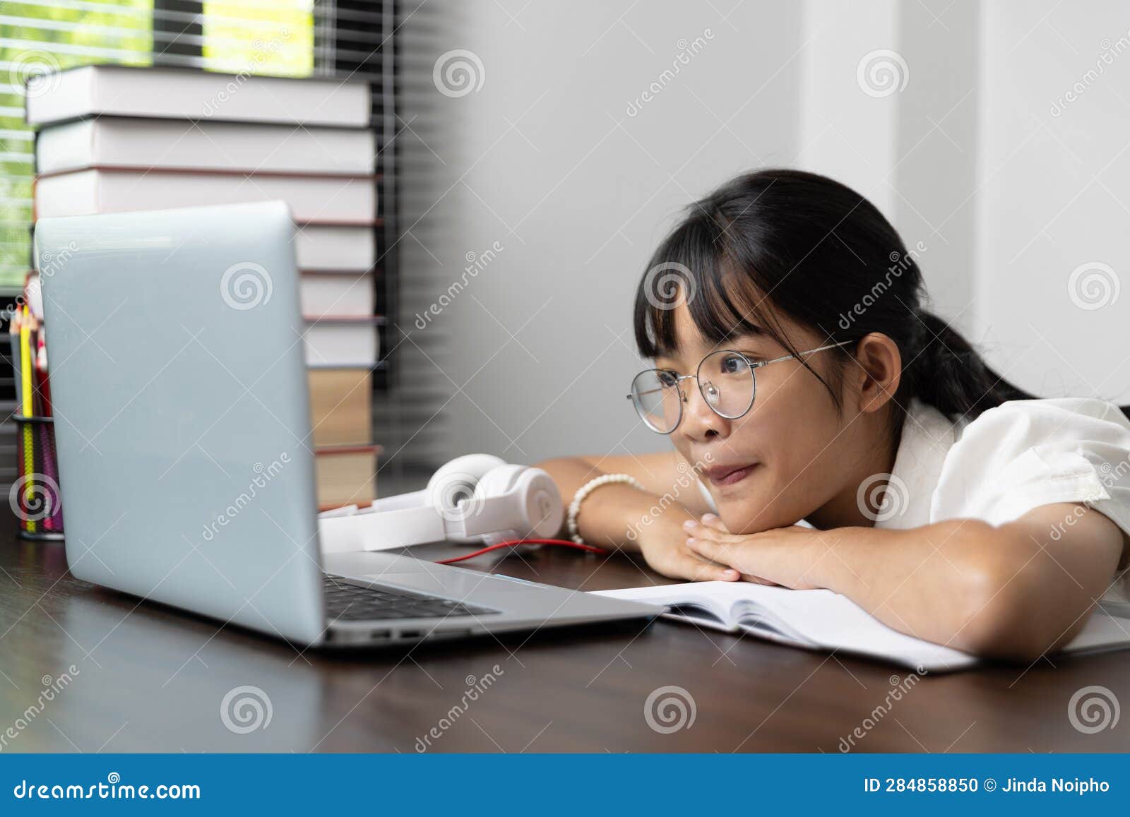 School Age Student Doing Her Homework with Digital Tablet at Home ...
