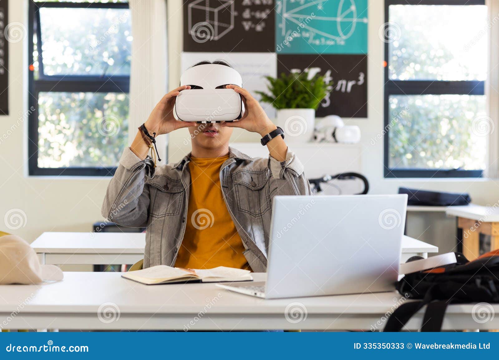 In School, Asian Teenage Boy Using VR Headset while Studying with ...