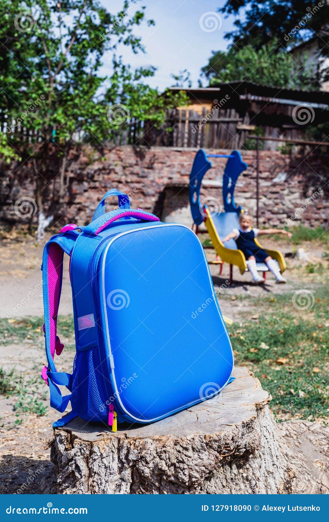 School Bag and an Elementary Student on Playground Stock Photo - Image ...