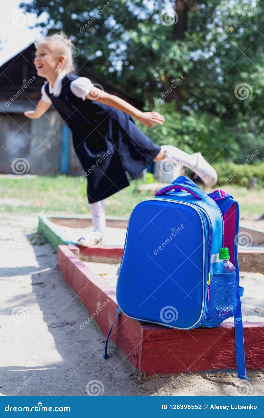 School Bag and an Elementary Student on Playground Stock Photo - Image ...