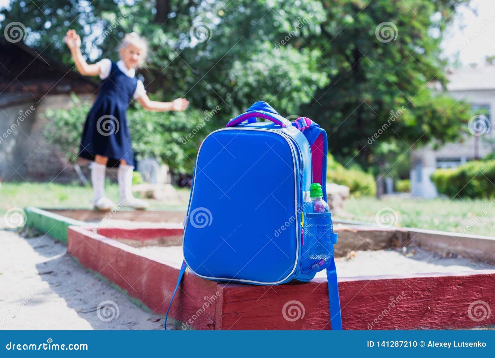 School Bag and an Elementary Student on Playground Stock Photo - Image ...