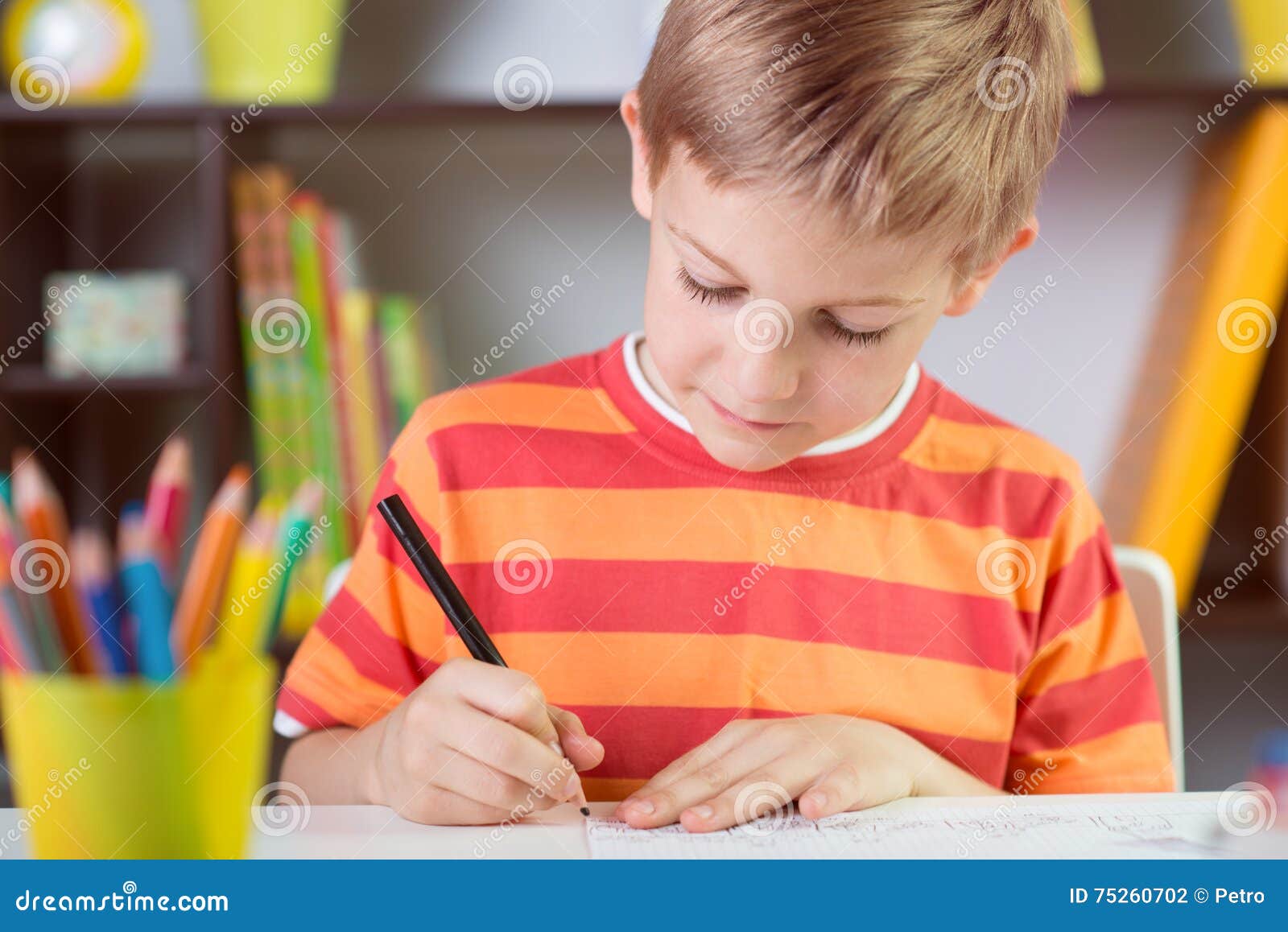 School Boy at Classroom Desk Making Schoolwork Stock Photo - Image of ...