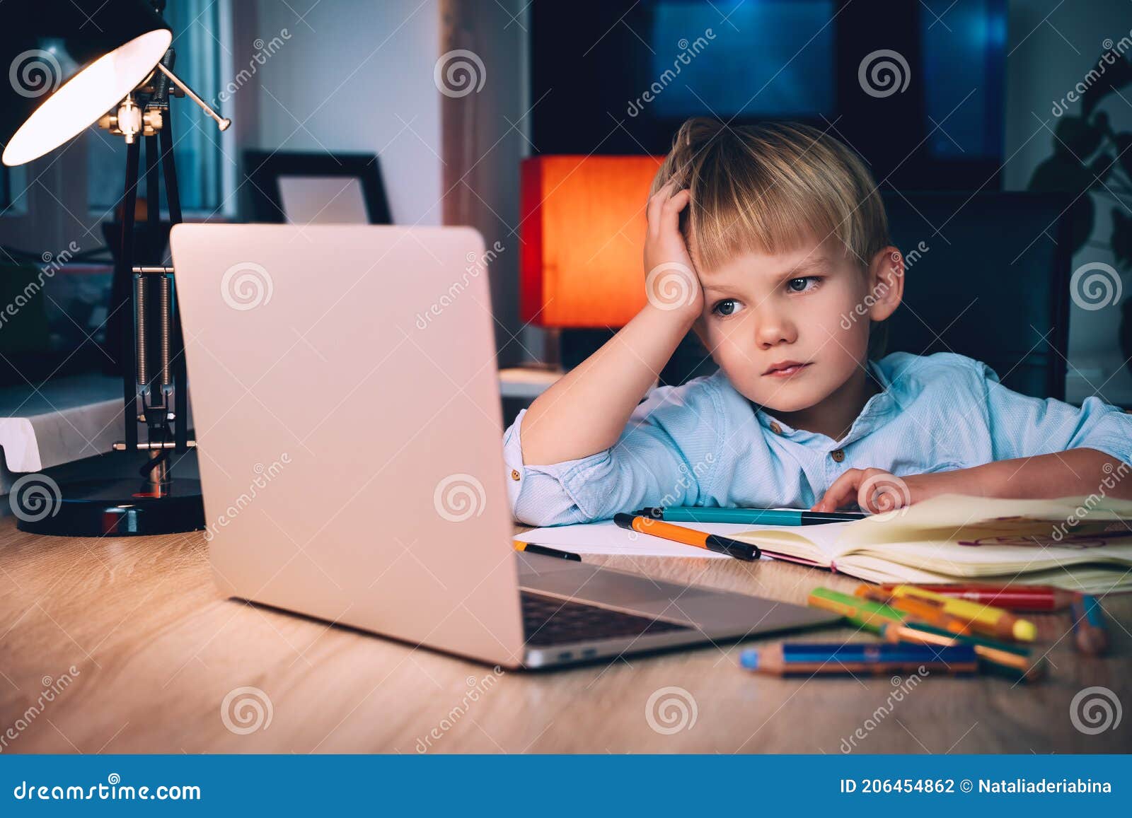 School Boy with Laptop at Table in Evening at Home Stock Photo - Image ...