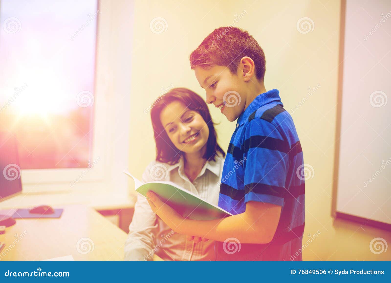 School Boy with Notebook and Teacher in Classroom Stock Photo - Image ...
