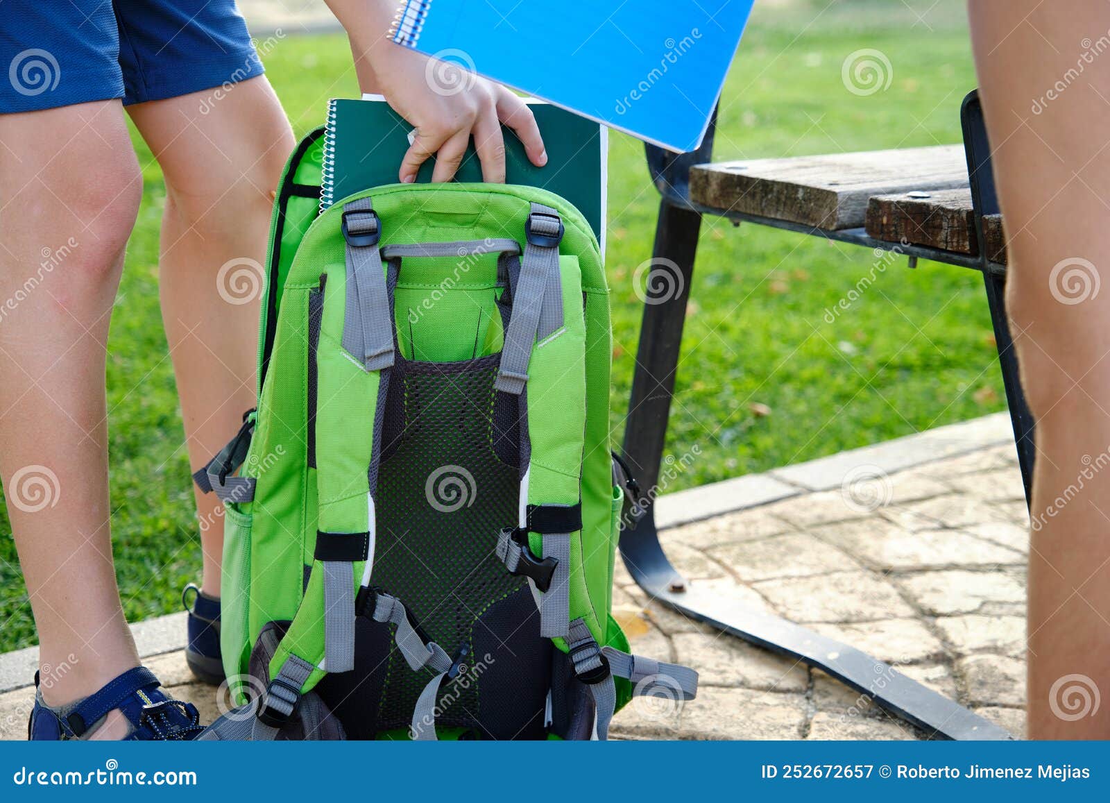 A School Boy Putting His File Folder with Homework Exercises into ...