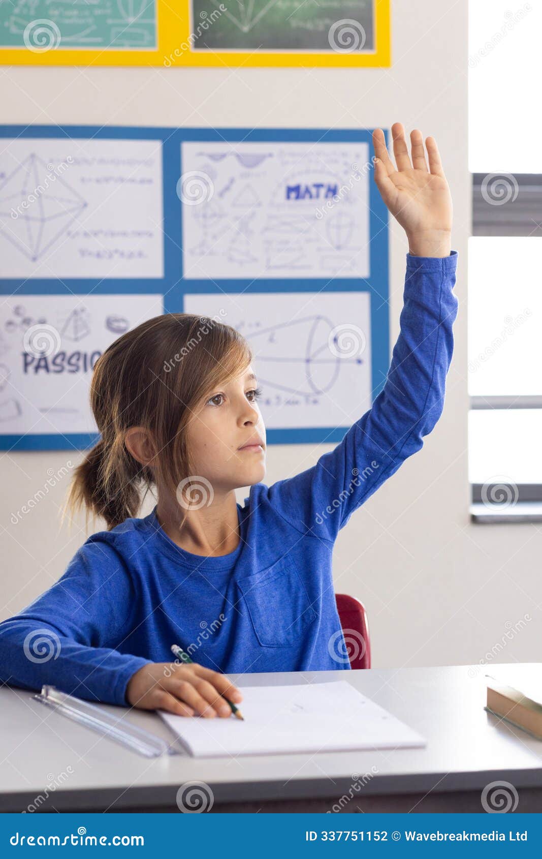 In School, Boy Raising Hand while Sitting at Desk with Notebook Stock ...