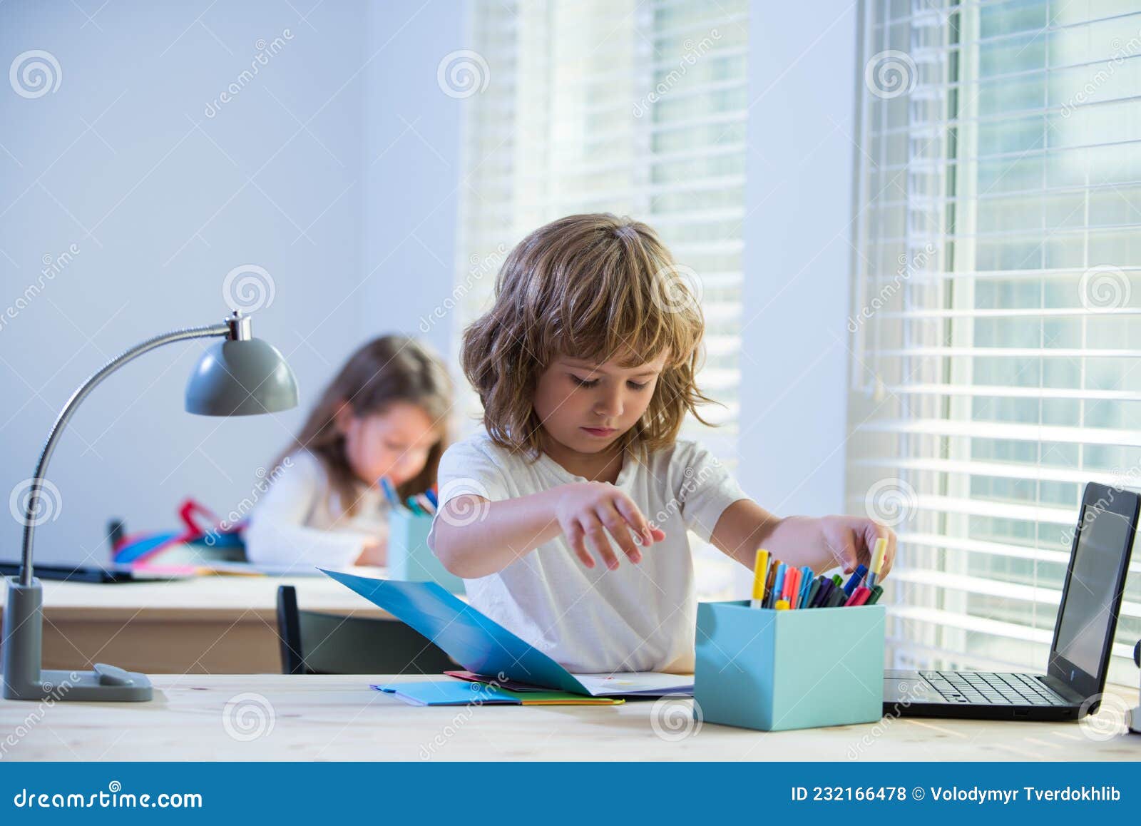 School Boy Sitting at the Table, Writing Homework or Preparing for the ...