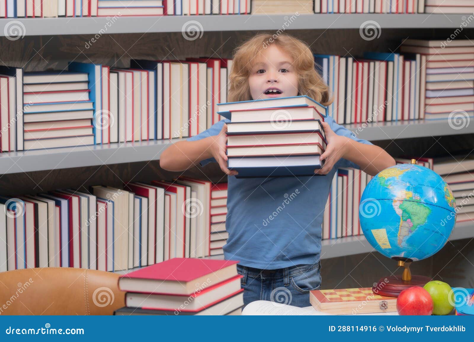 School Boy with Stack of Books in Library. Back To School Stock Photo ...