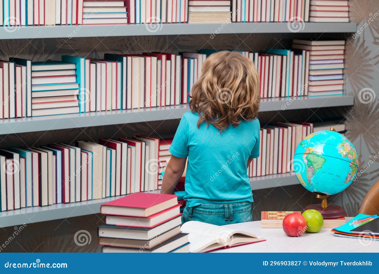 School Boy with Stack of Books in Library. Child from Elementary School ...