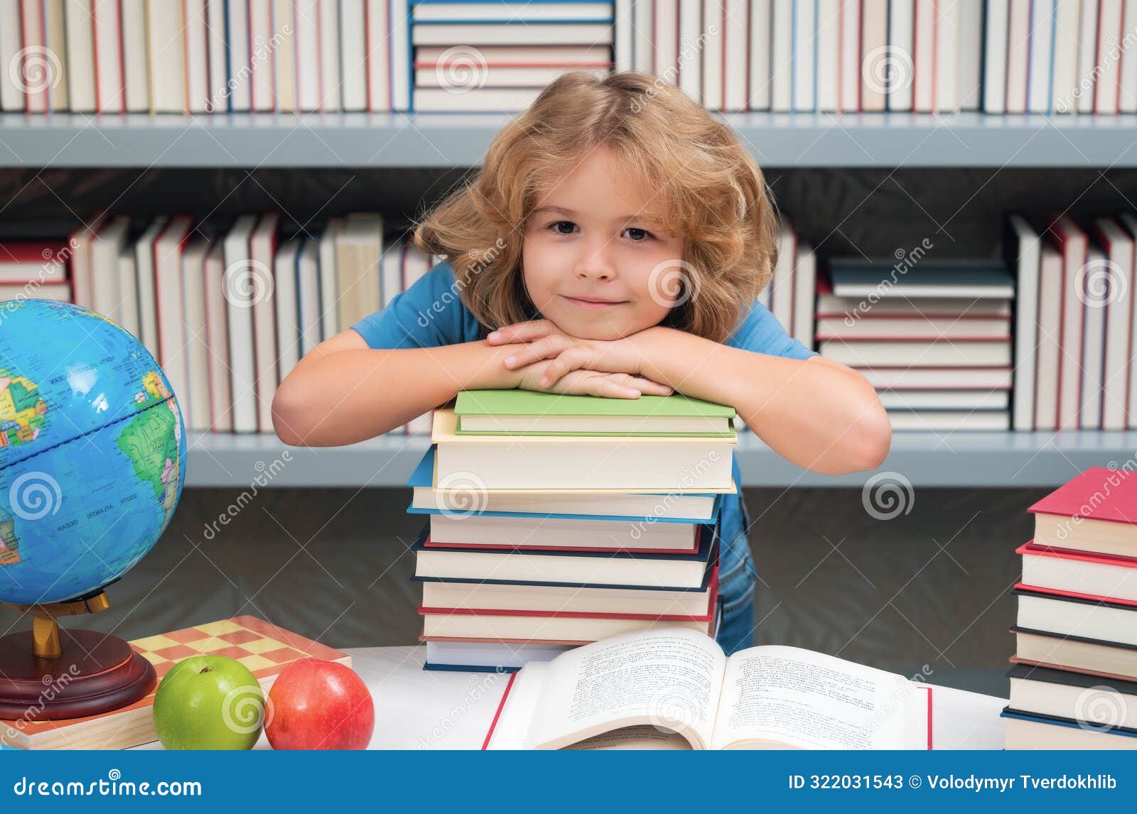 School Boy with Stack of Books in Library. School Child. Kid Boy from ...