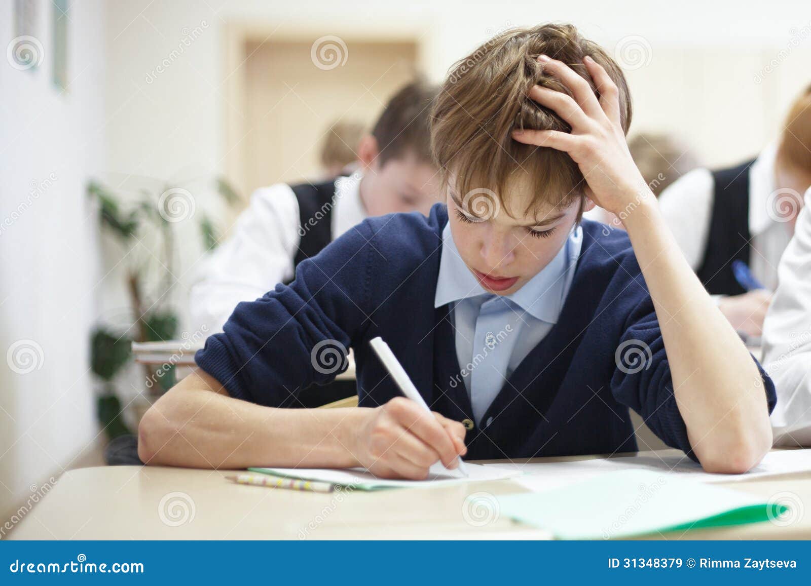 School Boy Struggling To Finish Test in Class. Stock Image - Image of ...
