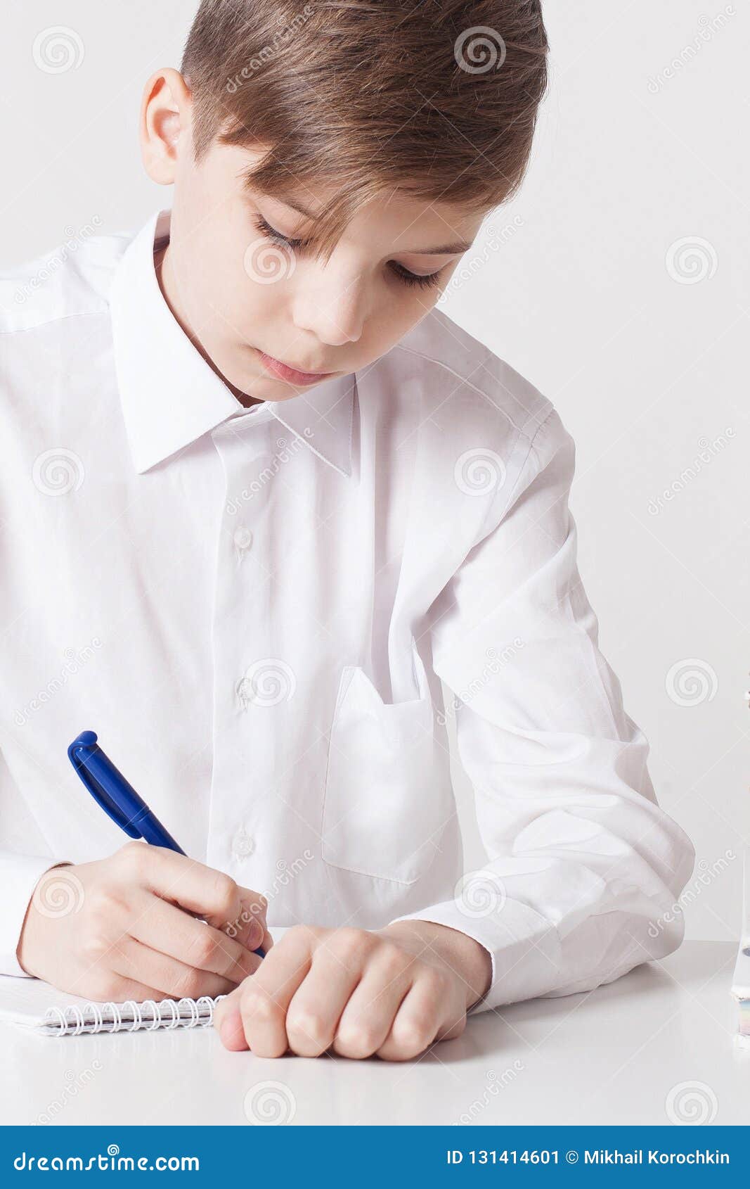 School Boy Writes in Notebook at the Table Stock Image - Image of books ...