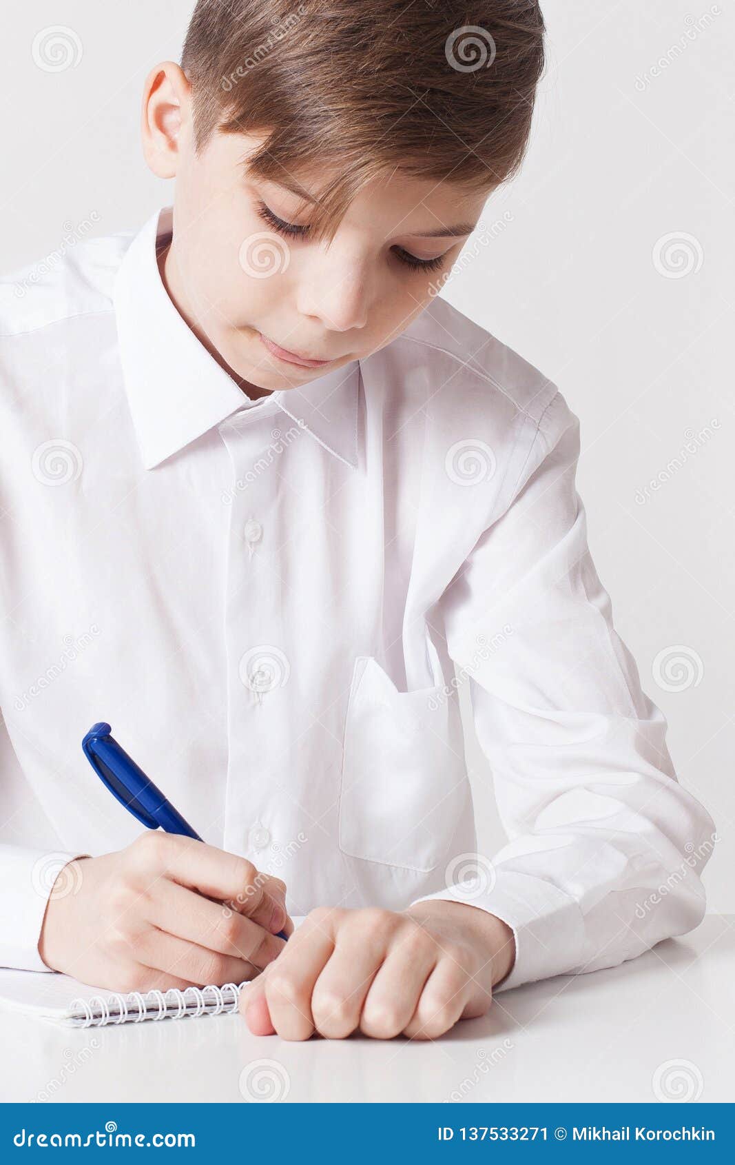 School Boy Writes in Notebook at the Table Stock Image - Image of face ...
