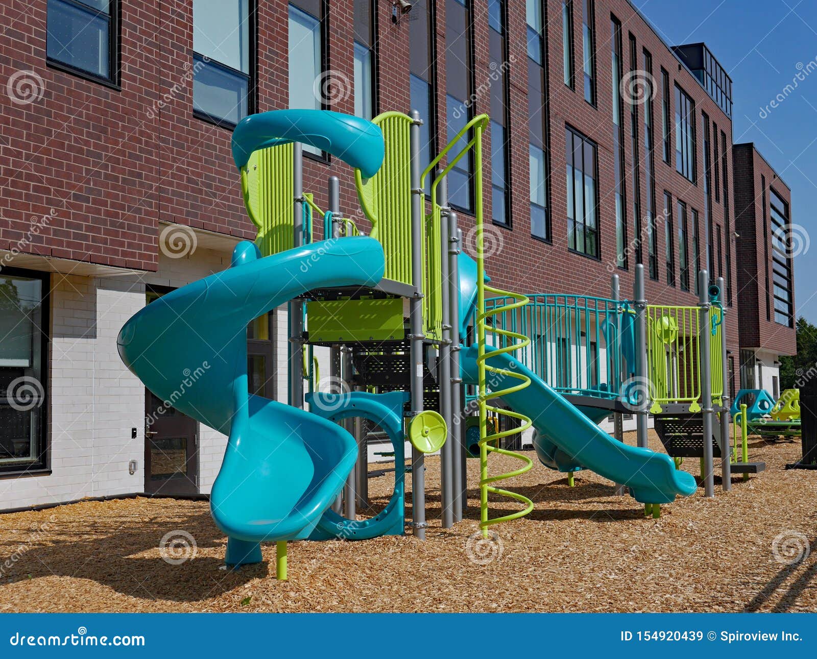 School Building with Playground Equipment Stock Image - Image of brick ...