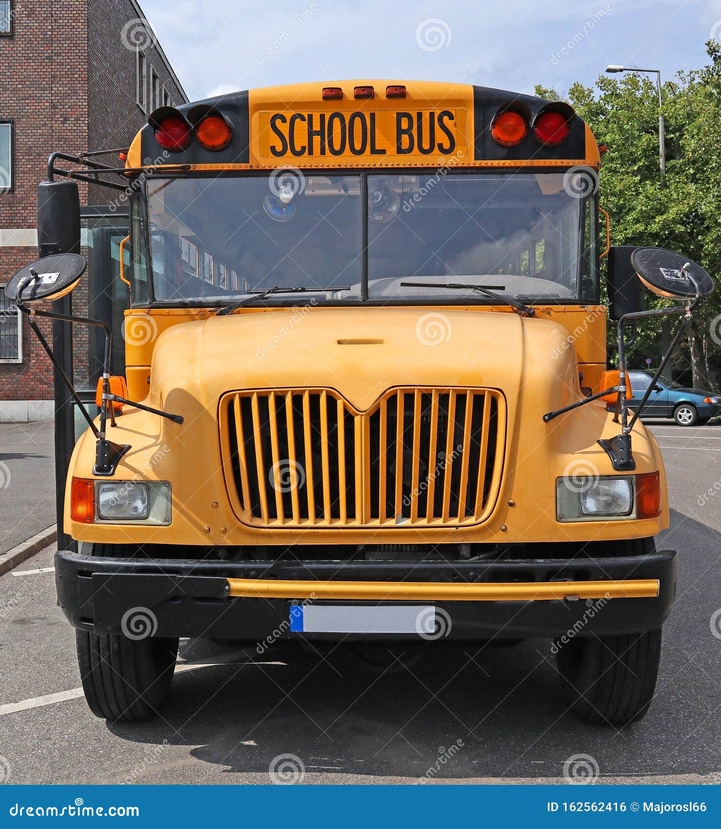 School Bus in the Parking Lot Stock Photo - Image of building, window ...