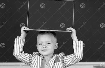 School Child Holding Laptop on Head Using Digital Pc Laptop in Class ...
