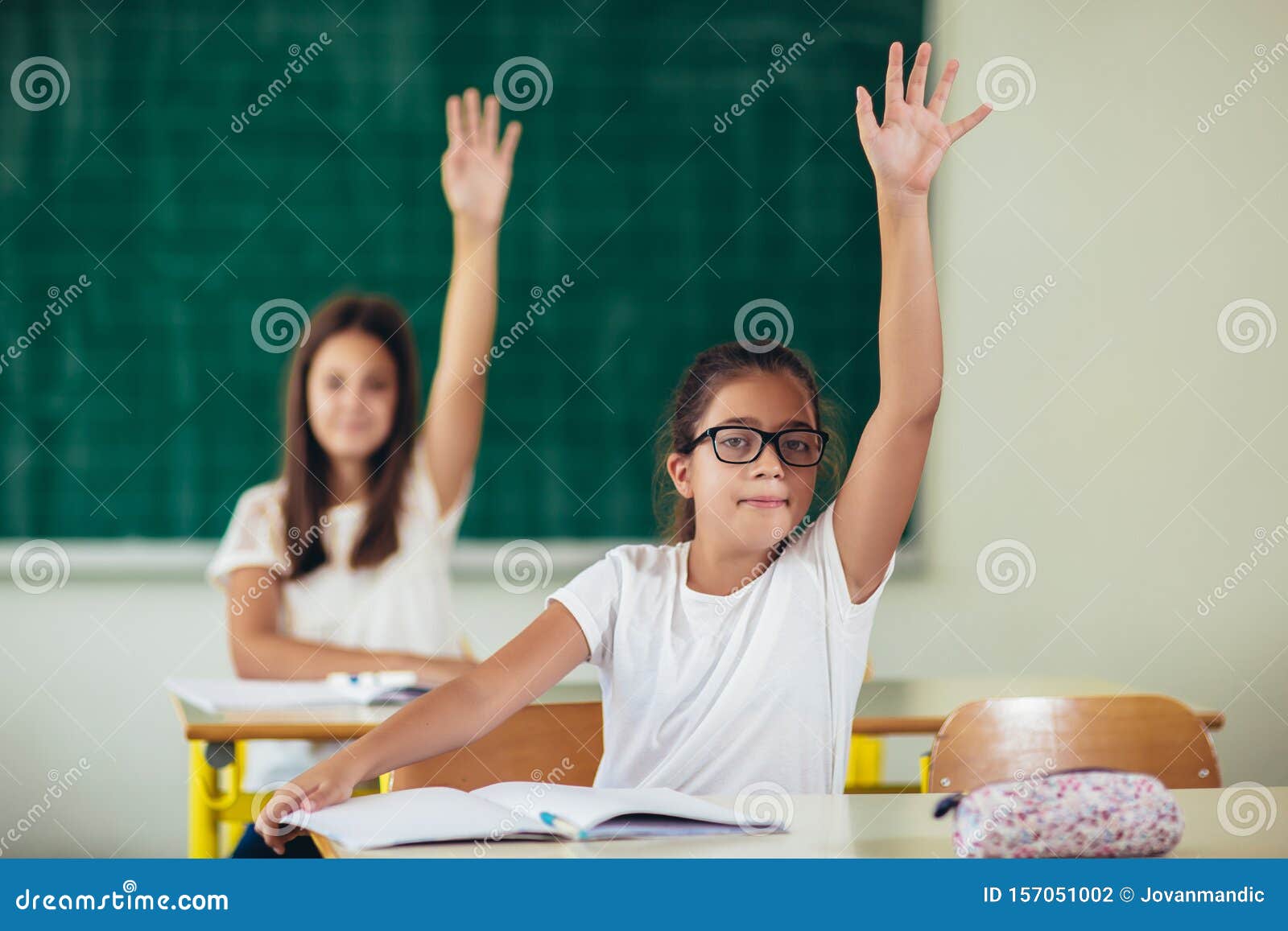 School Girls Raised Hands in Class Room Stock Photo - Image of hand ...