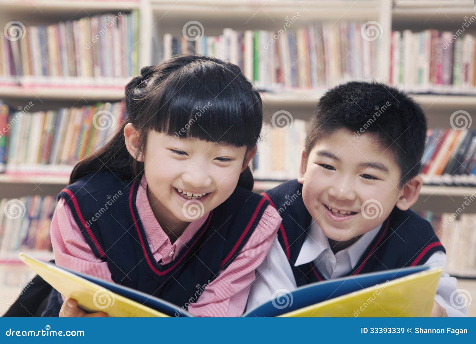 School Children Reading Book a in the Library Stock Image - Image of ...