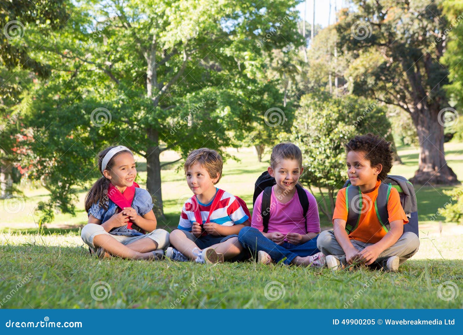 School Children Sitting on Grass Stock Image - Image of female, cute ...