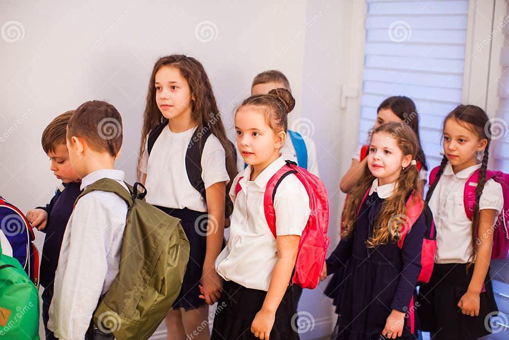 School Children in Uniform with Backpacks Going To Class Stock Image ...