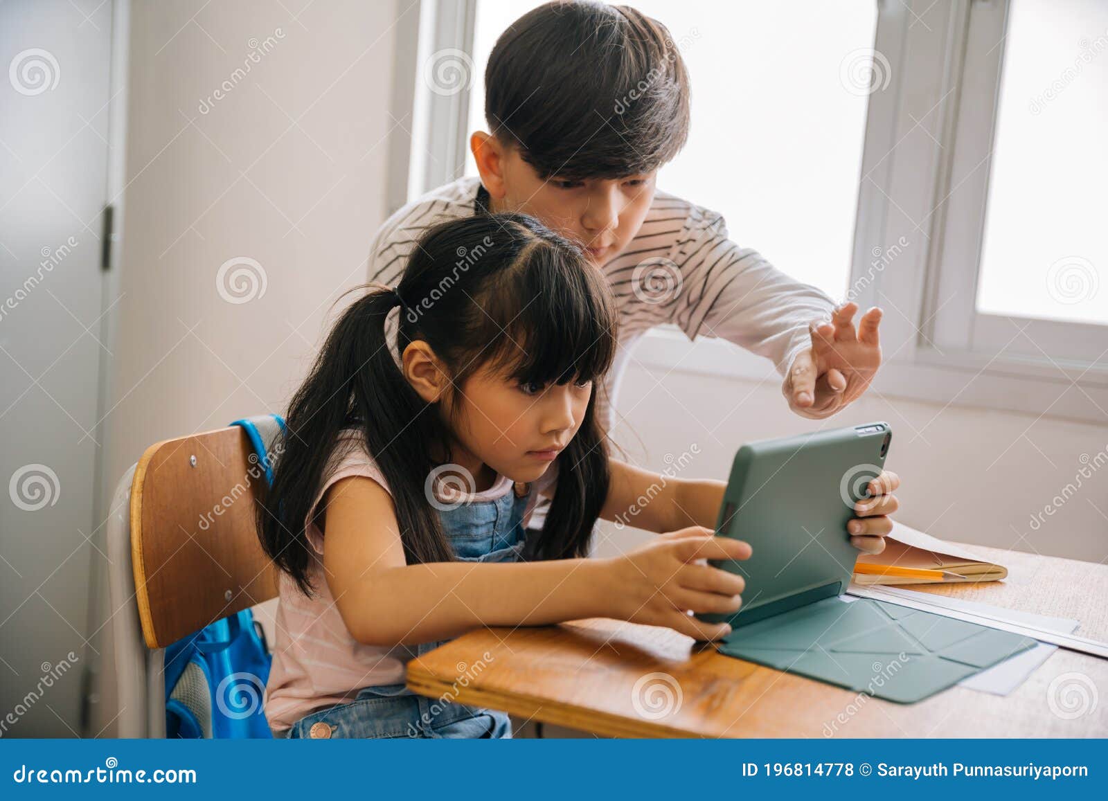 School Children Using Digital Tablet Device in School Classroom ...
