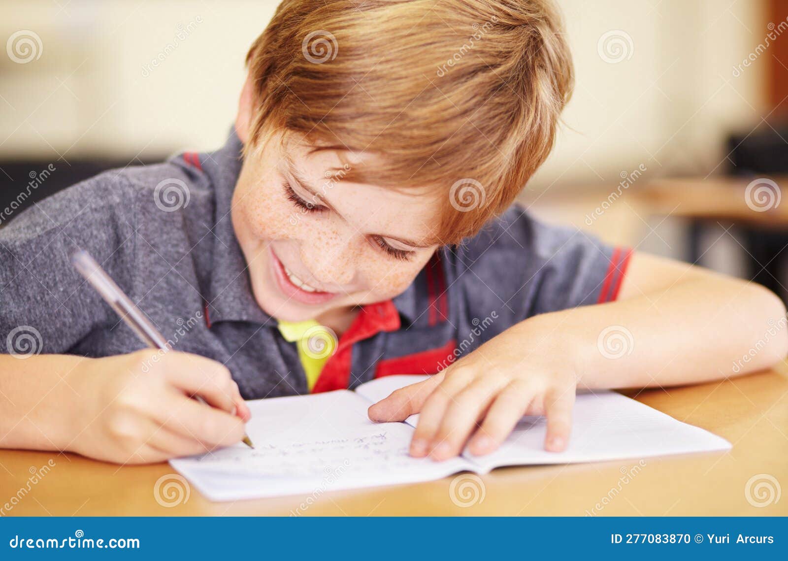 School, Education and a Student Boy Writing in a Book while Sitting at ...