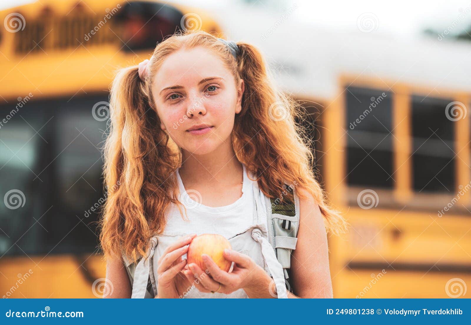 School Girl at the Front of the School Bus with Apple. Stock Photo ...