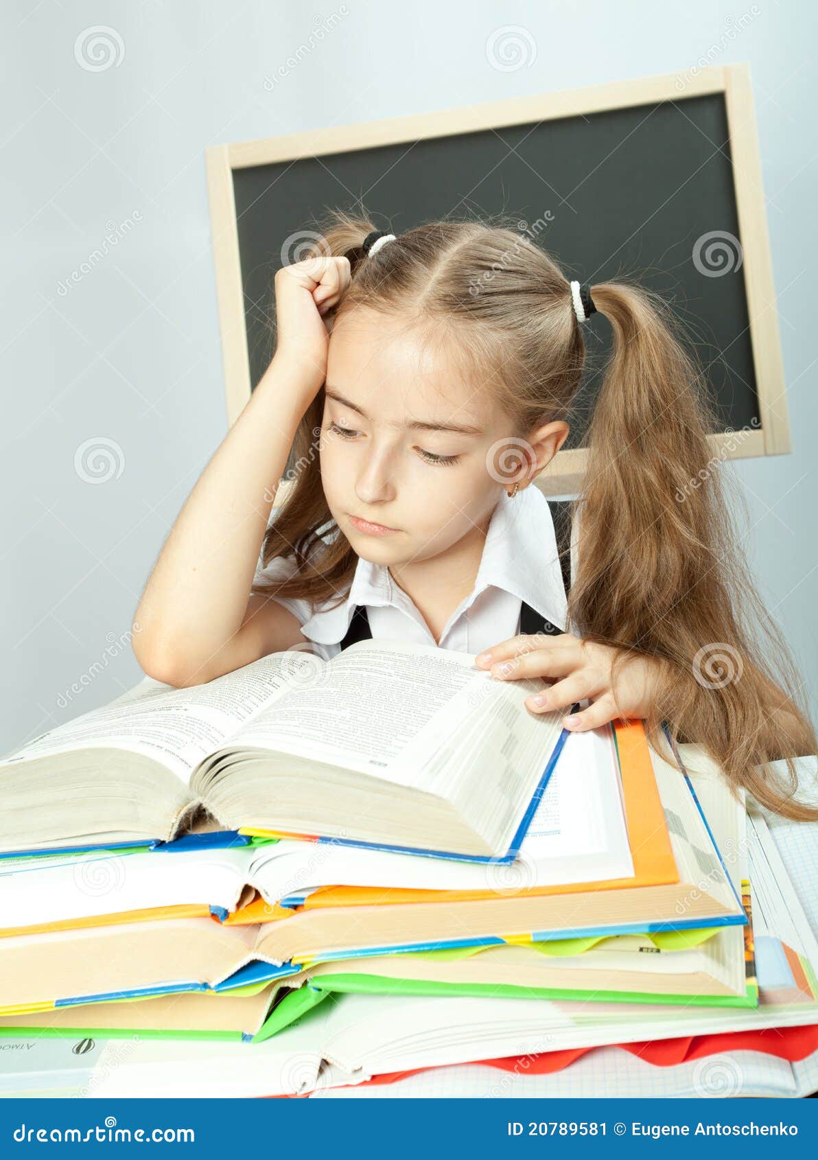 School Girl Making Homework Behind Stack of Books. Stock Image - Image ...