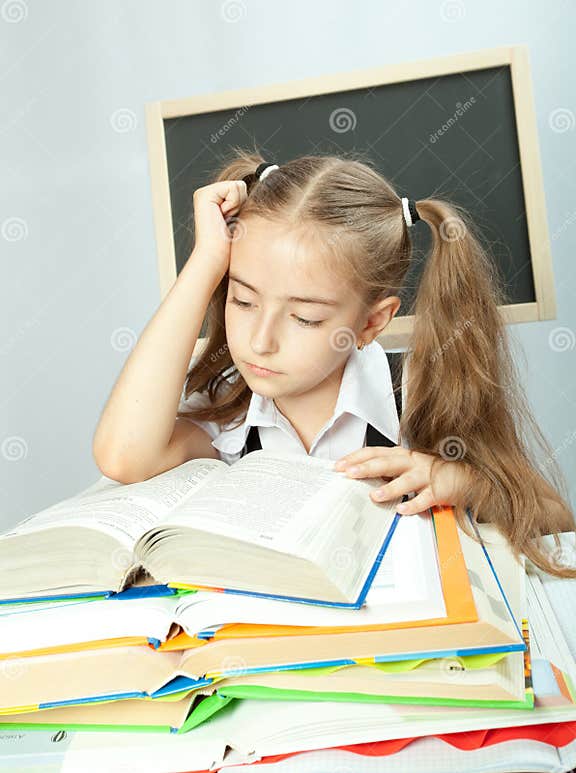 School Girl Making Homework Behind Stack of Books. Stock Image - Image ...