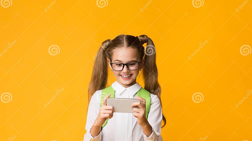 School Girl Playing Mobile Game On Phone Over Yellow Background Stock Image Image Of Excited 6204