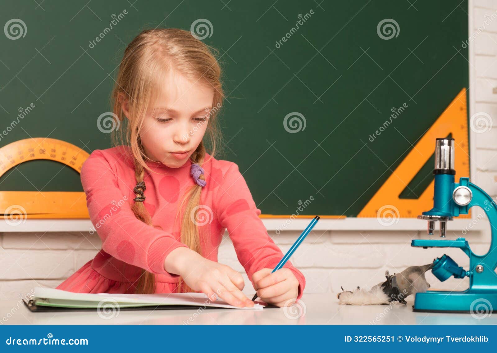 School Girl Writing in Notepad and Doing School Homework. Thinking ...