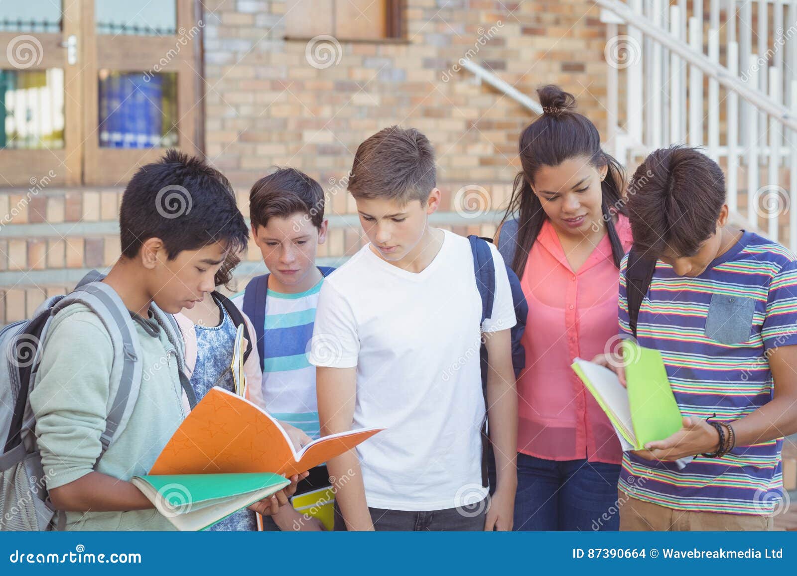 School Kids Discussing Over Text Book in Campus Stock Photo - Image of ...