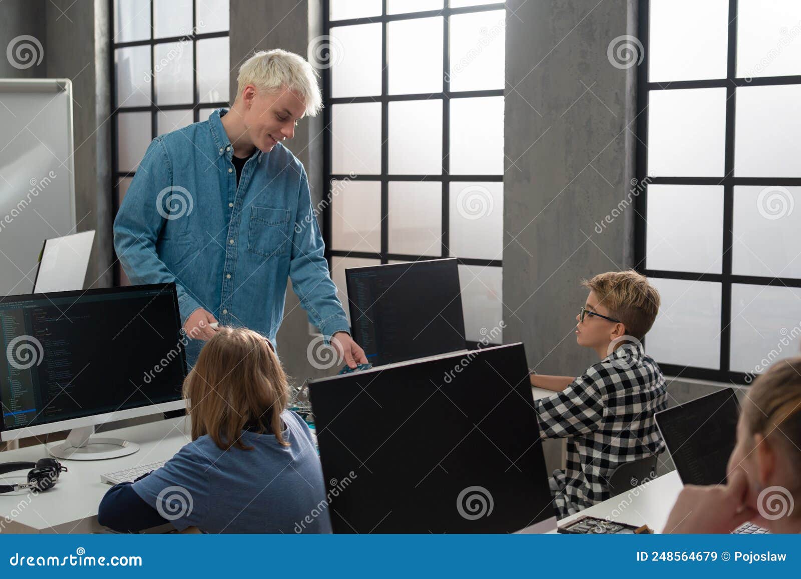 School Kids with Help of Teacher Using Computer in Classroom at School ...