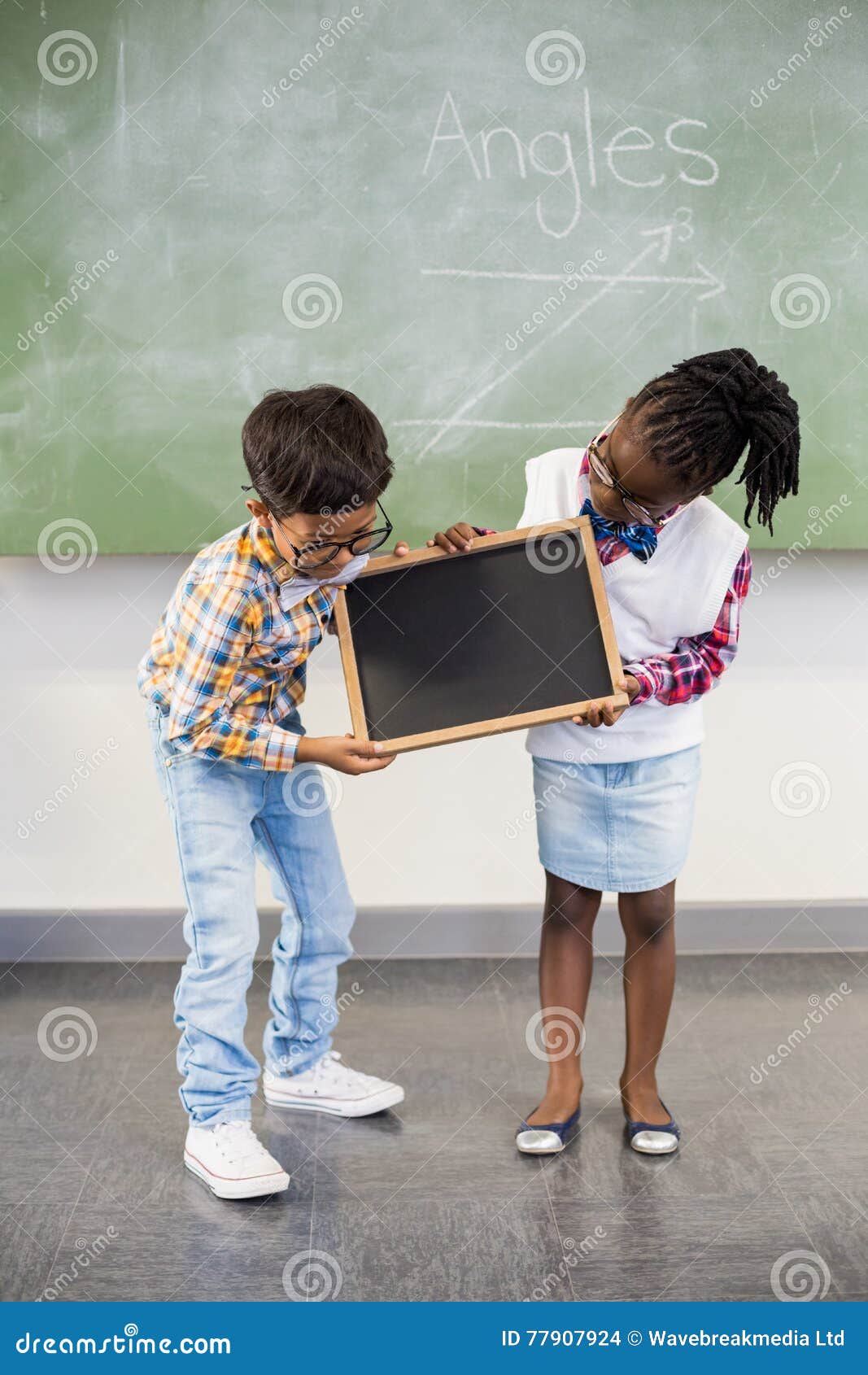 School Kids Looking at Slate in Classroom Stock Photo - Image of ...
