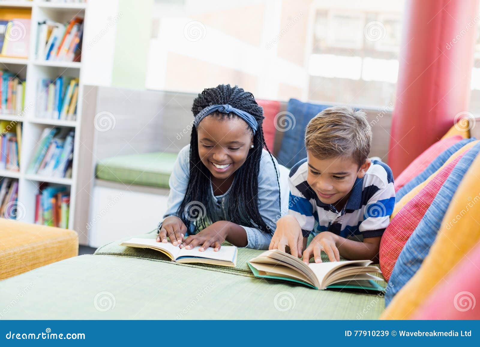 School Kids Lying on Sofa and Reading Book Stock Image - Image of ...